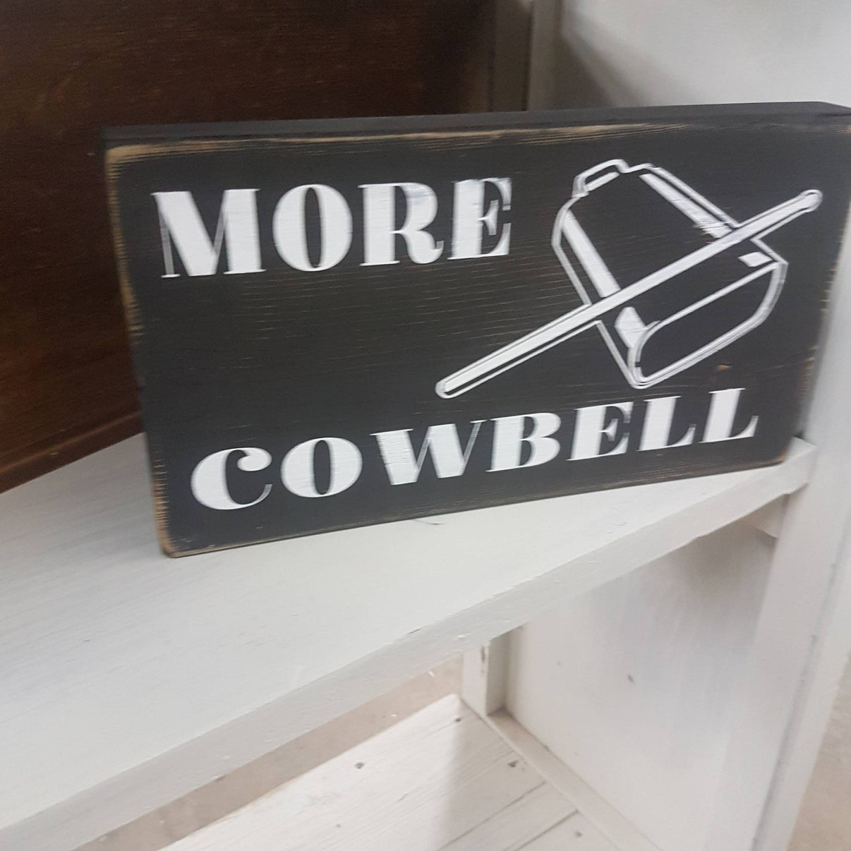 Wooden sign needs MORE COWBELL – Wainfleet Trading Post